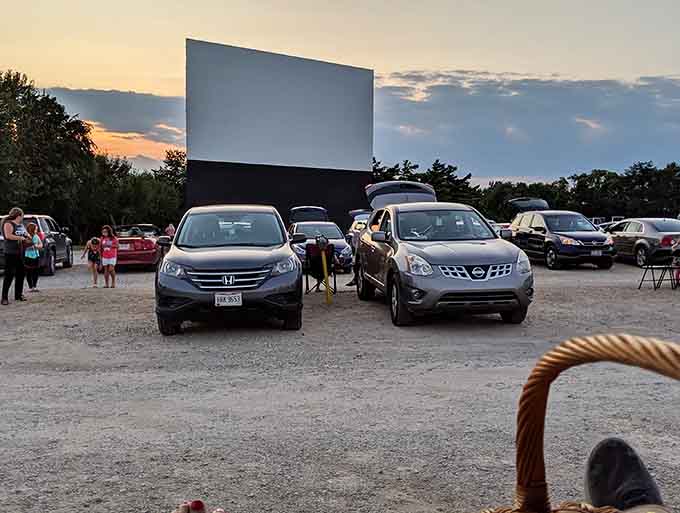 Cars align with military precision, each angled perfectly toward the screen &ndash; a choreographed dance of vehicles preparing for their evening entertainment.