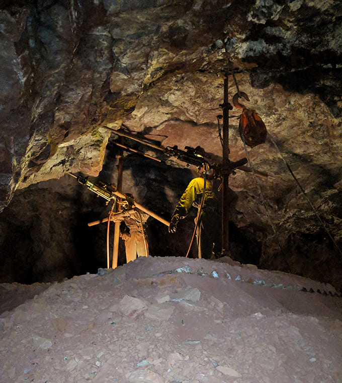 Engineering in action: A glimpse of the drilling equipment that made mining possible, operated by skilled hands in challenging conditions.