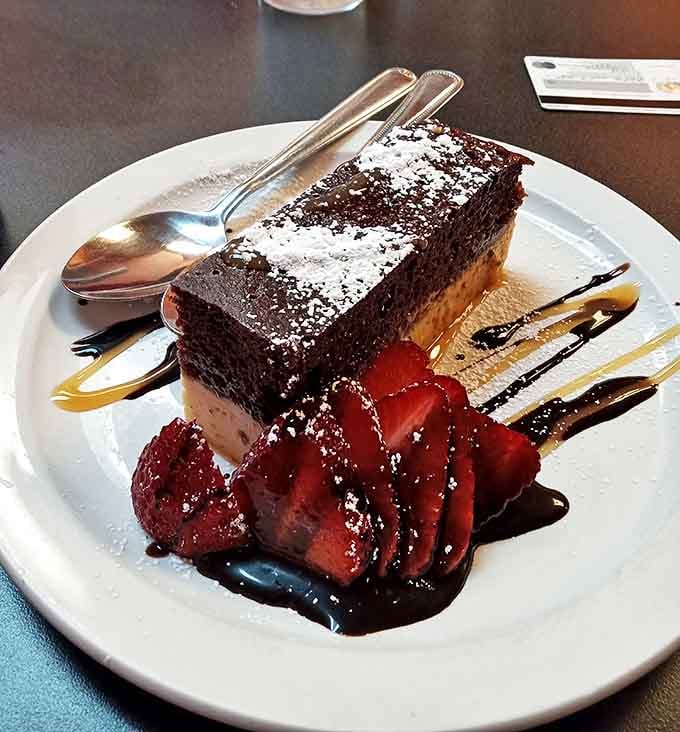 The tres leches cake sits innocently on its plate, not revealing that it's about to deliver a milk-soaked miracle to your taste buds.