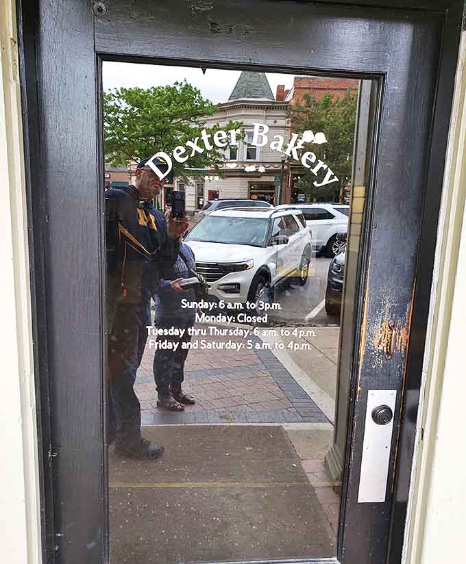 The door reveals not just operating hours but a portal to another dimension where calories don't count and joy comes glazed.