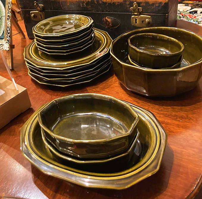Olive green stoneware dishes with their distinctive octagonal edges stand ready to bring retro charm to contemporary dinner tables.