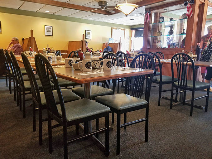 Coffee Mill mugs stand at attention on laminate tables, ready to deliver caffeine with the efficiency of a small-town gossip network.