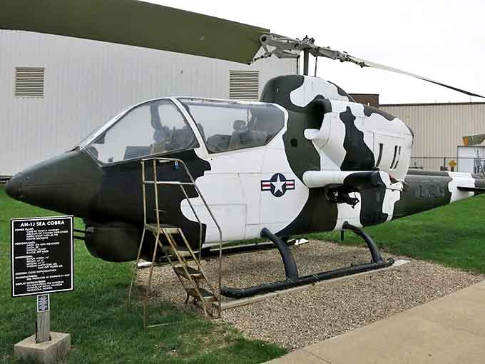 The menacing AH-1J Sea Cobra, with its distinctive tandem cockpit, looks ready to lift off despite decades of retirement.