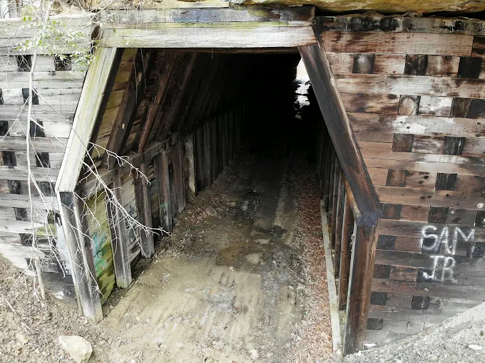Another Upper View: The tunnel's mouth yawns beneath the weight of earth and stone, a testament to engineering that defied nature's gravity.