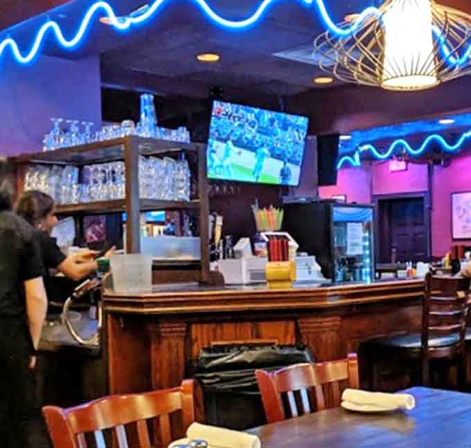 The bustling bar area where stories flow as freely as the cocktails &ndash; a gathering place for regulars and newcomers alike.