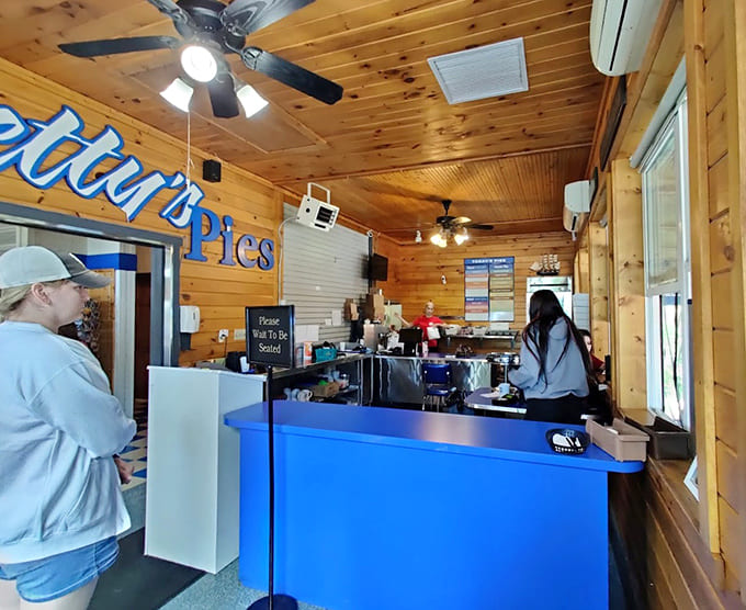 The warm wooden interior of the ordering area welcomes guests like an old friend, promising sweet rewards for those patient enough to wait their turn.