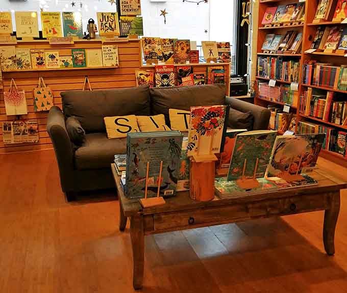 This inviting couch with its Scrabble-tile pillow practically whispers, "Stay awhile," creating the perfect spot for young readers to discover new worlds.