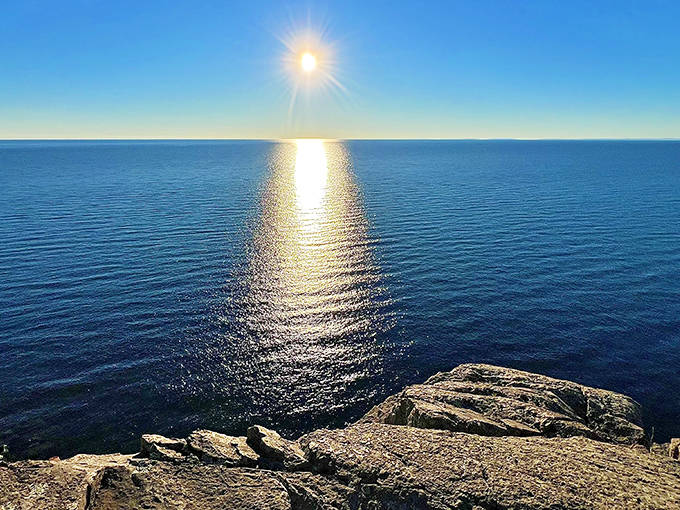 Sunlight creates a golden pathway across Lake Superior, as if inviting visitors to follow it to some magical destination.