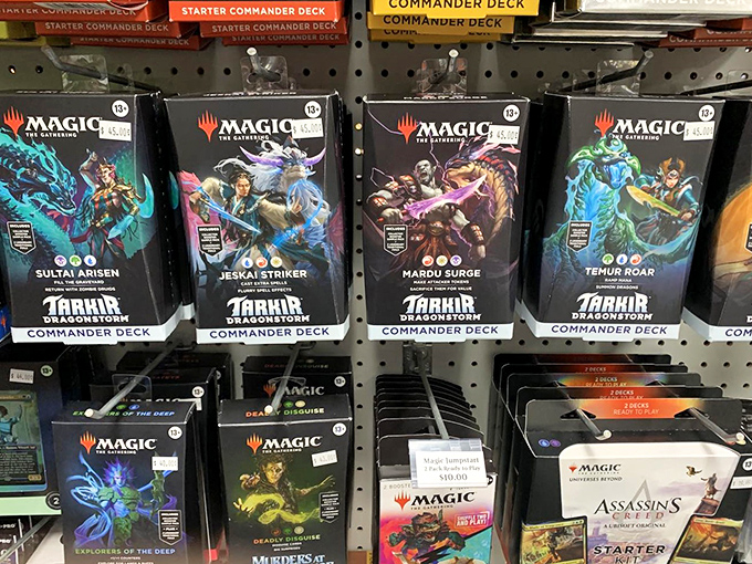 Commander Decks line the shelves like literary classics, each one containing carefully crafted strategies waiting to be unleashed.