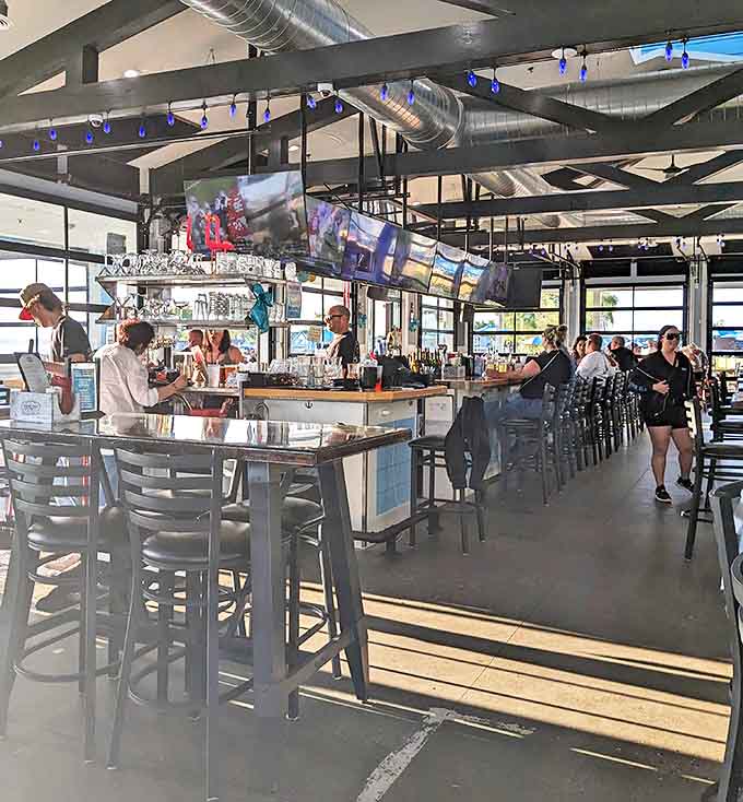 The bar area gleams with promise, offering front-row seats to the mixology magic and a perfect perch for solo diners.