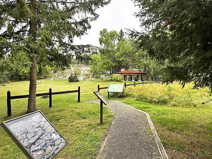 Interpretive signs guide visitors along winding pathways, offering context without intruding on the contemplative experience of discovering each garden section.