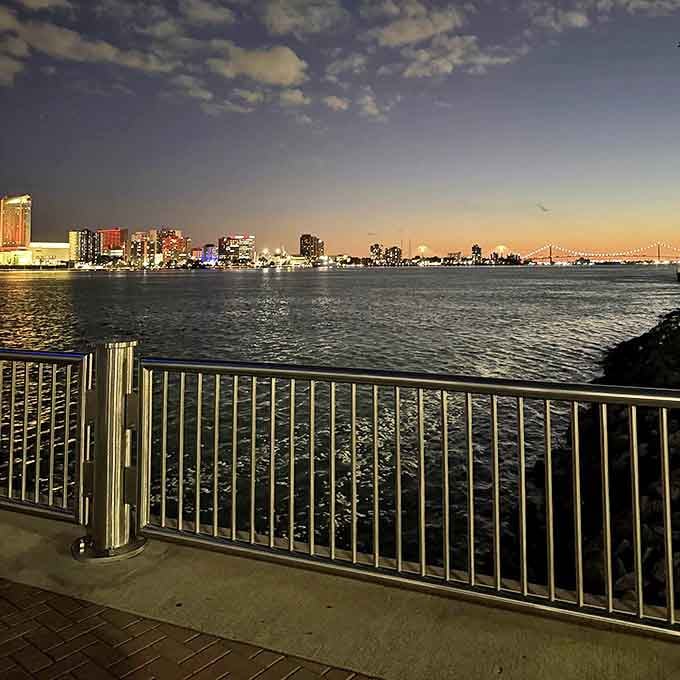As night falls, Detroit's skyline transforms into a constellation of earthbound stars, their light dancing across the river's dark surface.