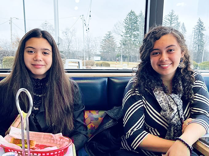 Happy diners enjoying their meal in the comfortable booth seating &ndash; creating memories one bite at a time.