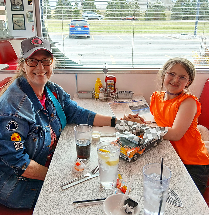 Dining companions enjoying a moment of connection that no smartphone notification could ever replace &ndash; the real magic of diners captured in one frame.