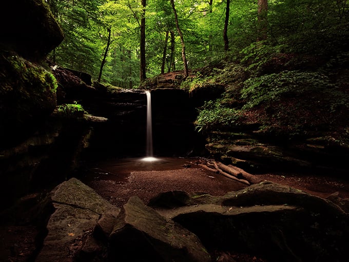 The forest opens to reveal this hidden waterfall vista, rewarding hikers with a view worth every step of the journey.
