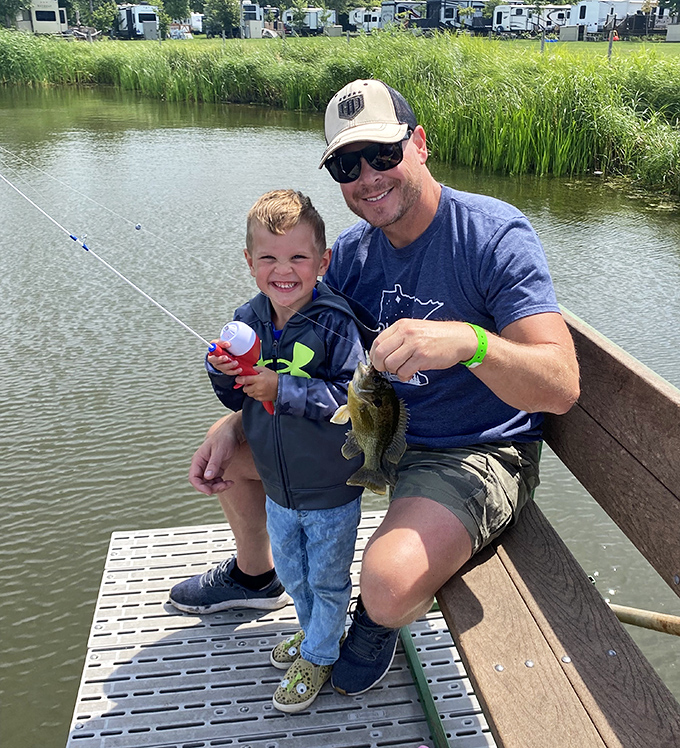 The timeless art of patience rewarded with aquatic trophies. That proud smile says "I caught dinner!" even if it's clearly going back.