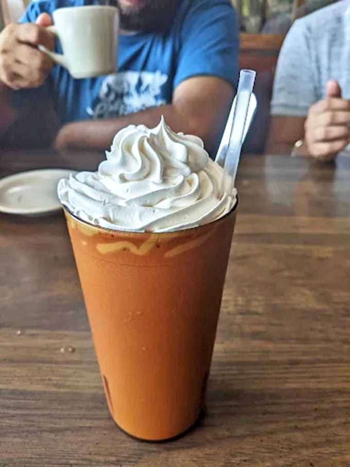 Iced coffee topped with whipped cream, because even cold drinks deserve a little extra happiness on top.