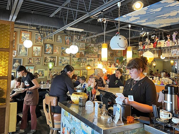 Efficient staff navigate the packed dining room with practiced grace. The counter seating offers front-row views of breakfast magic in the making.