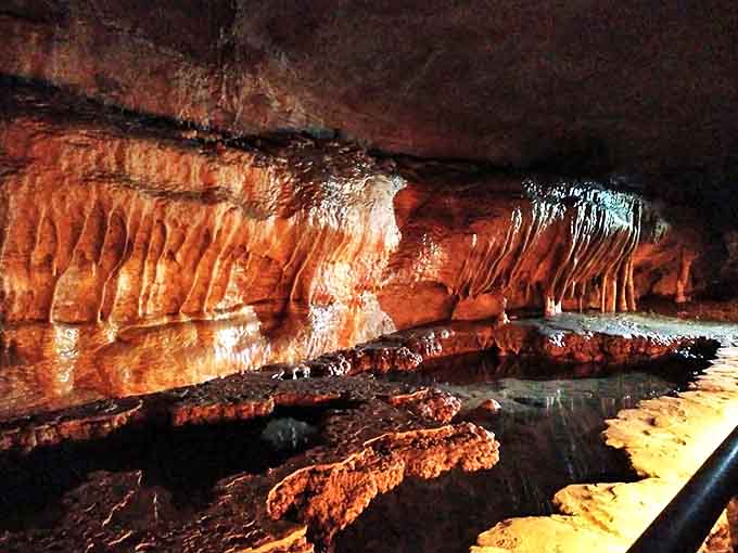 Nature's stained glass: Mineral-rich water creates these stunning amber-hued formations, illuminated to showcase their translucent beauty.