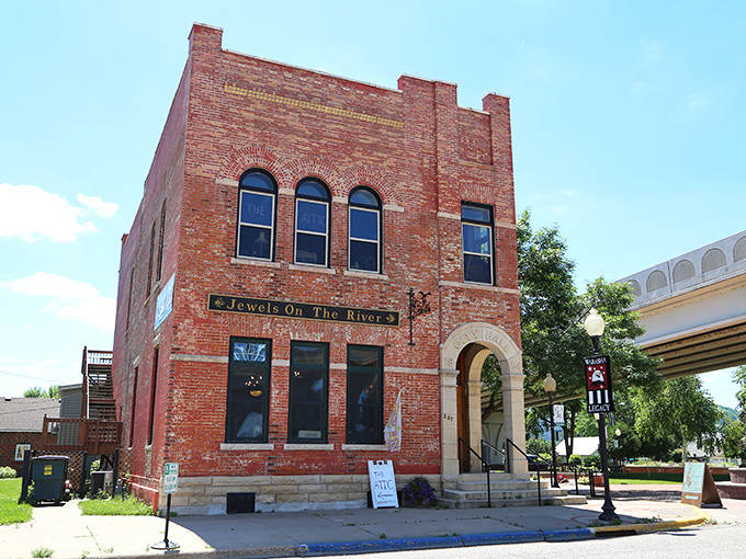 Jewels on the River occupies a distinctive brick building where arched windows frame displays of local artistry and Mississippi-inspired craftsmanship.