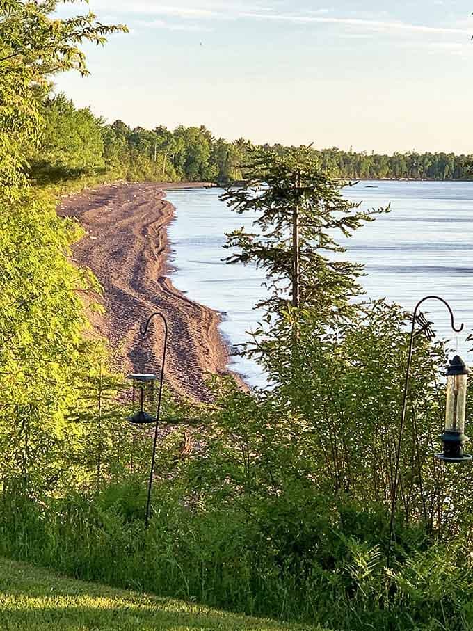 The private beach stretches invitingly along Superior's shore, where footprints in the sand become part of the day's ephemeral art collection.
