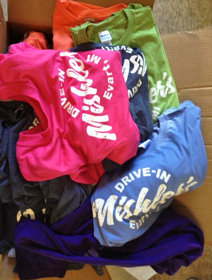 Wearable bragging rights: Colorful Mishler's t-shirts have become local status symbols, proudly proclaiming membership in the Pizza Burger fan club.