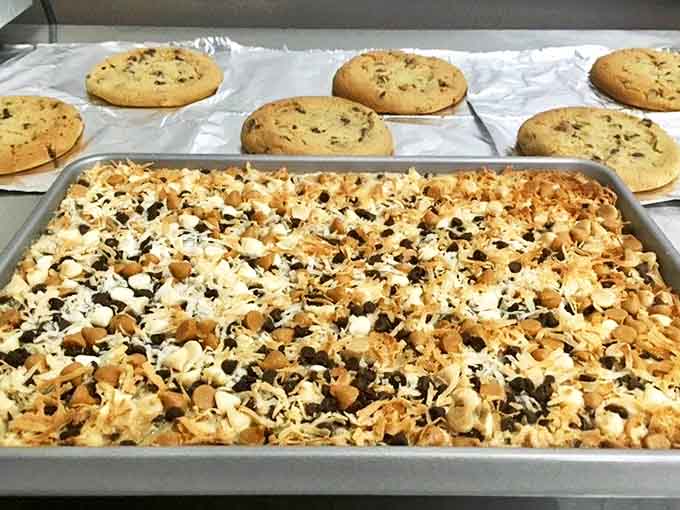 Magic cookie bars loaded with chocolate chips, coconut, and butterscotch create a dessert situation that's basically everything good layered together.