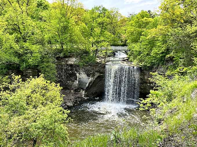 Minneopa State Park's waterfall cascades dramatically through lush greenery, creating Minnesota's answer to tropical paradise.