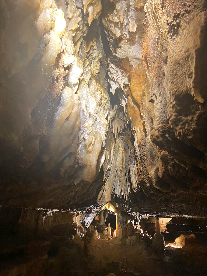 Stone pillars and archways frame the cavern passages, creating natural doorways into chambers filled with geological treasures.