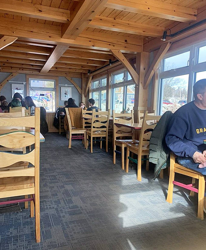 Timber-frame construction and thoughtful design create a dining space that feels both spacious and intimately connected to its surroundings.