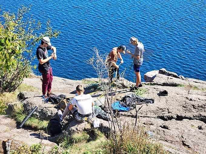 Visitors gather at Palisade Head's edge, experiencing that perfect blend of awe and vertigo that only true natural wonders provide.