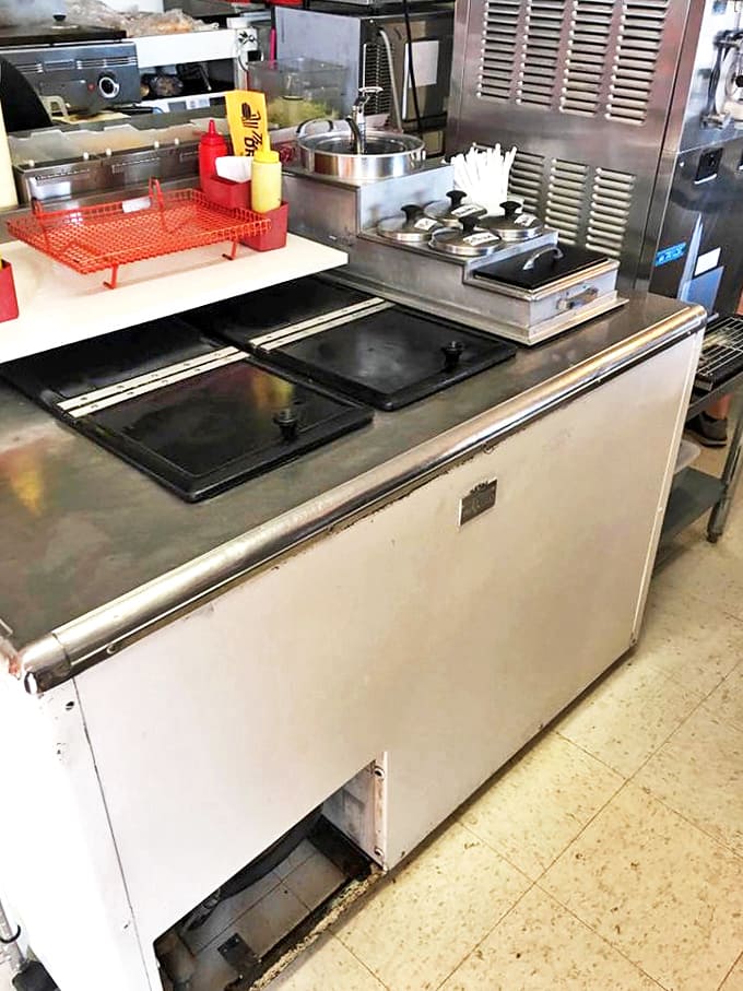 Where the magic happens &ndash; the grill master works his craft in the compact kitchen, continuing decades of coney-making tradition.