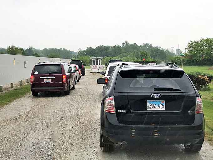 Cars line up with patient excitement, each vehicle containing its own private viewing party within the larger communal experience.