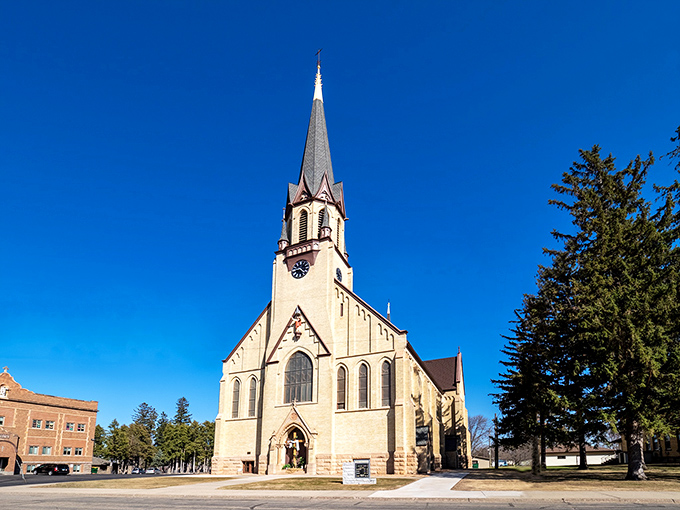 Sacred Heart Church's majestic spire reaches skyward, a limestone testament to faith and community that anchors the town.
