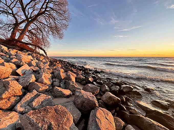 The rocky shoreline stands as nature's breakwater, where Lake Michigan's waves have played the same rhythmic tune for millennia.