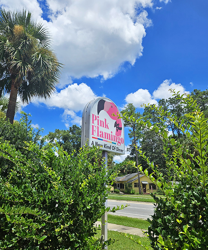 The Pink Flamingo sign stands against Florida's blue sky, a beacon of retro charm that promises more than just a meal.