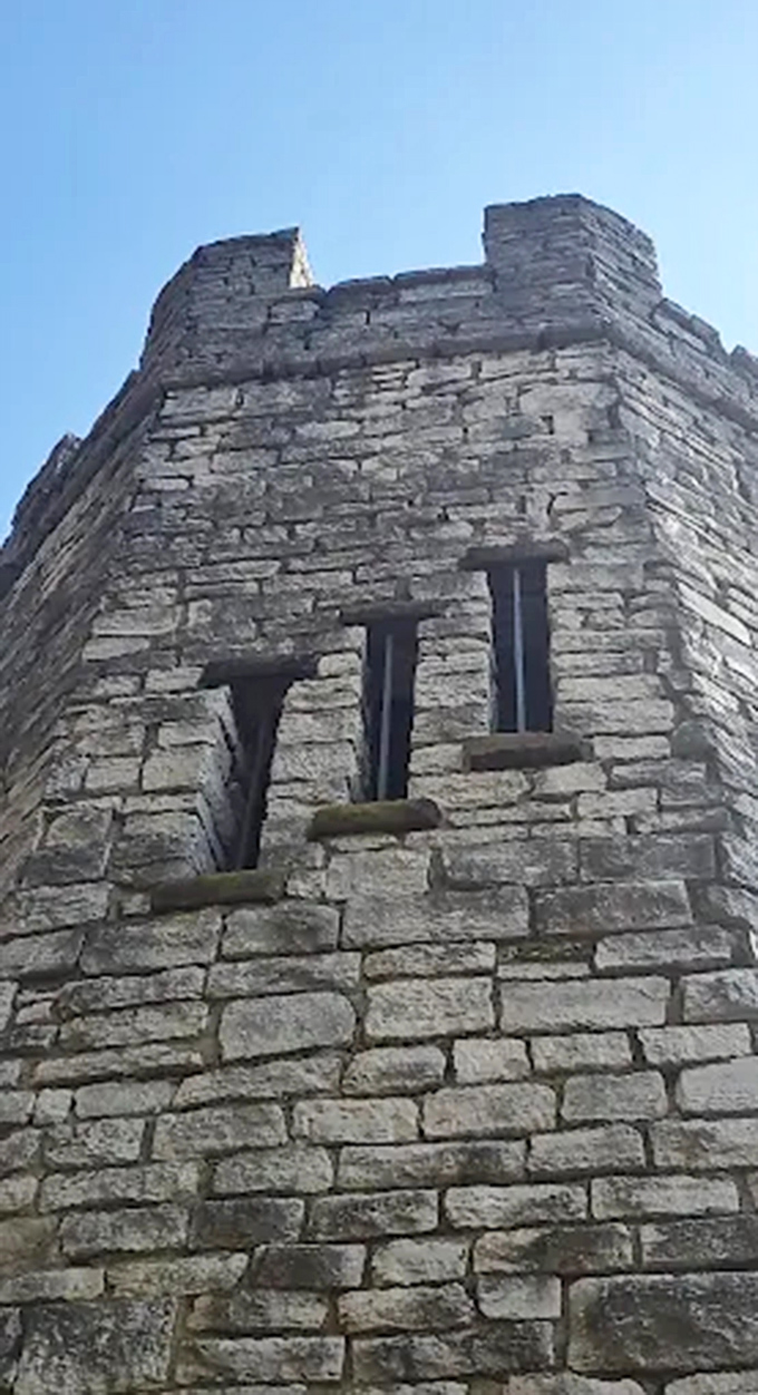 Narrow windows pierce the tower's thick stone walls, designed more for architectural character than practical defense.