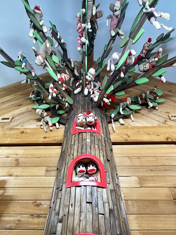The sock monkey tree displays dozens of the handcrafted creatures perched among wooden branches – a primate family reunion.
