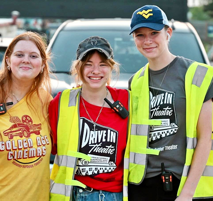 The friendly staff sport their drive-in gear with pride, ready to guide visitors through an evening of outdoor cinema magic.