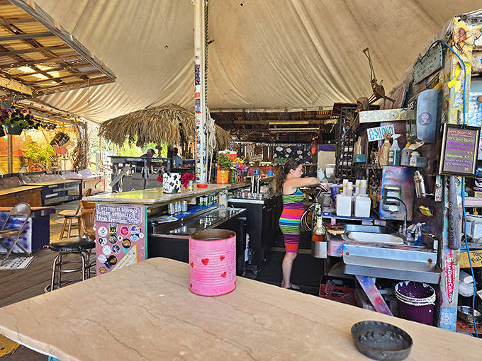 The staff moves with practiced efficiency behind a bar that looks like it was assembled during a particularly creative game of Jenga.