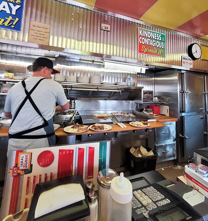 The grill master orchestrates a symphony of sizzling breakfast meats and eggs, a culinary conductor whose stage is a well-seasoned flat top.