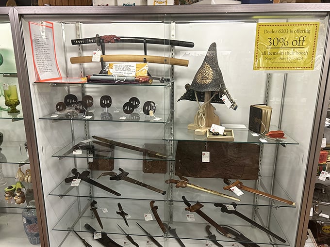 Sharp history! This case of vintage swords and weaponry appeals to collectors fascinated by military history and craftsmanship of bygone eras.