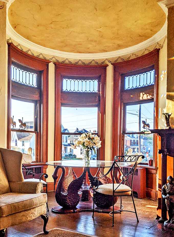 Sunlight streaming through curved windows onto period furniture: proof that the best Instagram filters are actually just really good architecture and natural light.