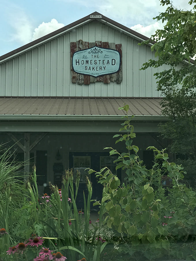 The bakery building stands proud among gardens and greenery, inviting you to step inside and stay awhile.