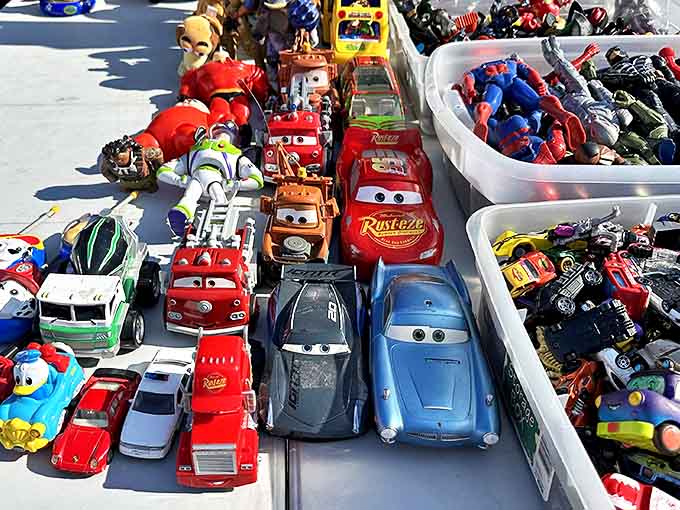 Toy cars and action figures create a miniature world of imagination – childhood dreams lined up in colorful plastic perfection.