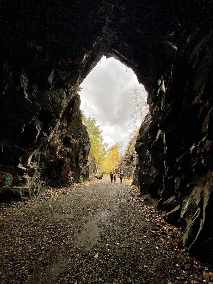 Inside the tunnel, geological wonders await as ancient rock layers tell Earth's story in dramatic bands of color and texture.