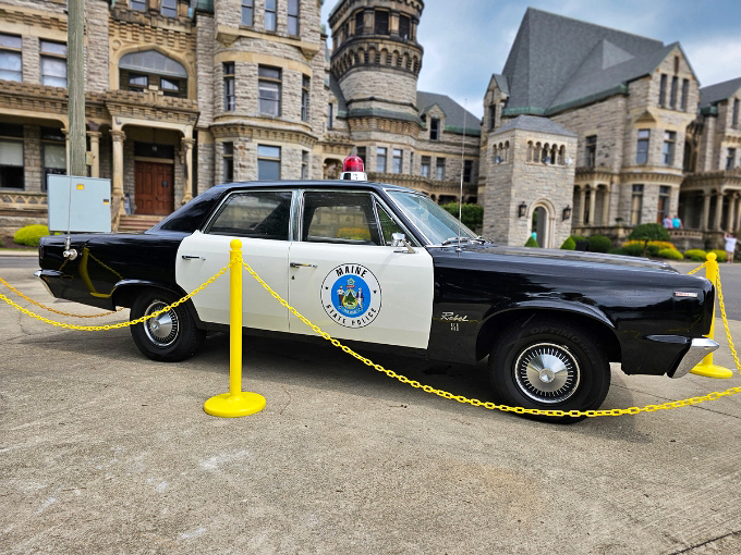 The vintage police cruiser parked outside the reformatory recalls an era when these vehicles transported new inmates to their limestone home.