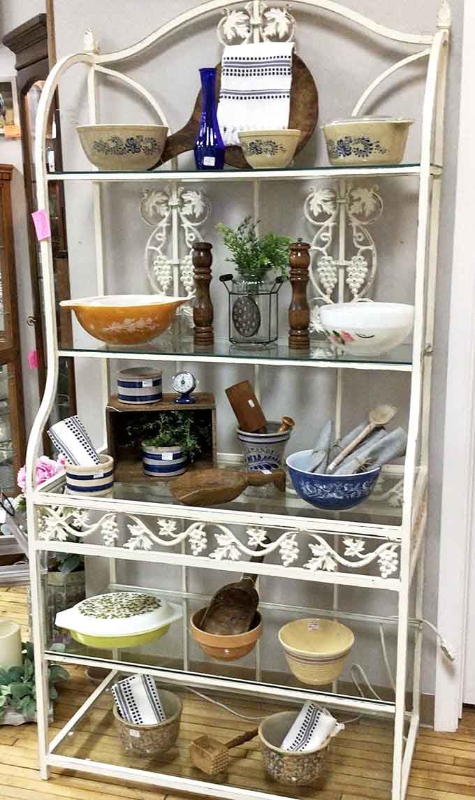 This elegant white baker's rack doesn't just display vintage kitchenware—it tells the story of family gatherings and recipes passed down generations.