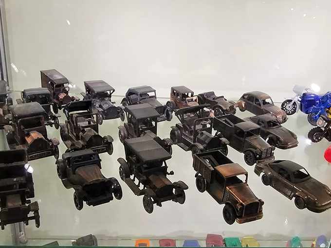 A fleet of meticulously crafted vintage automobiles proves that even the humblest office tool can become a canvas for automotive nostalgia.