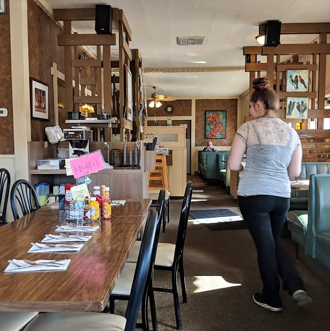 Wooden dividers and warm tones create intimate dining spaces without sacrificing the communal feel that makes diners so special.